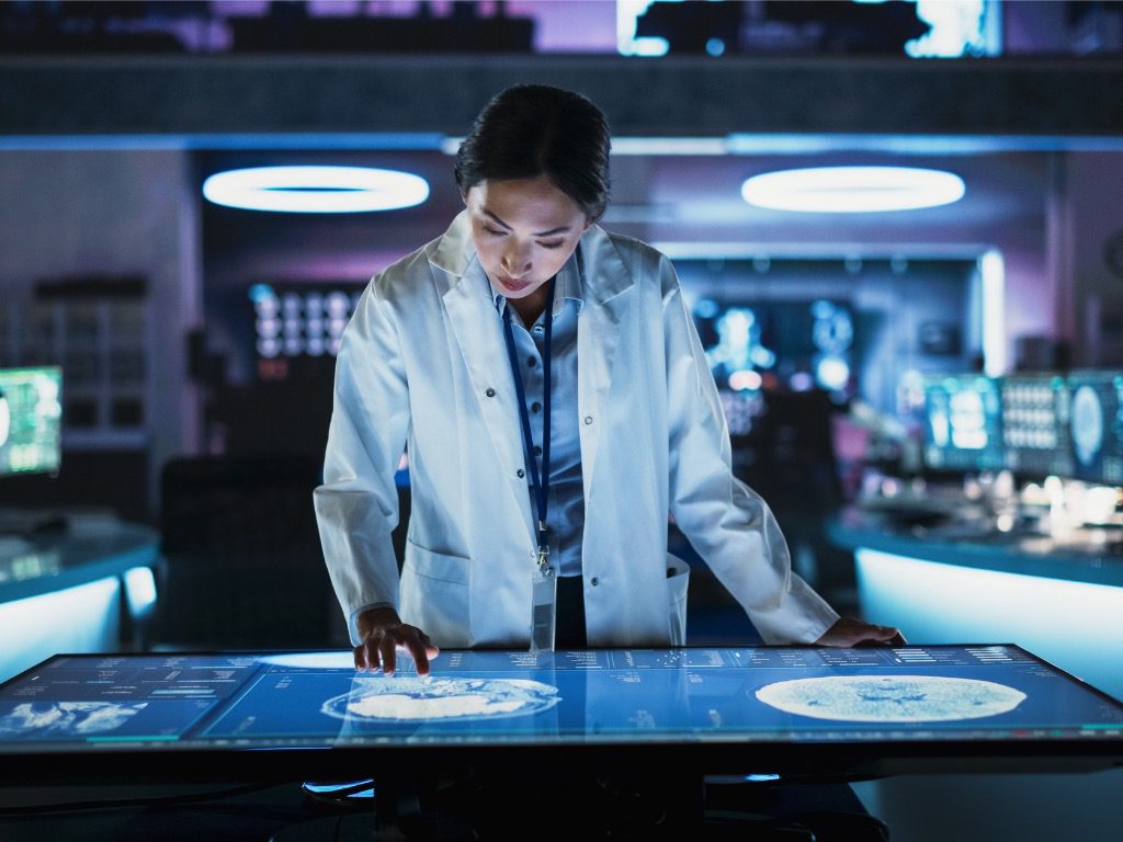 female-asian-neuroscinetist-using-interactive-touch-screen-table-with ...